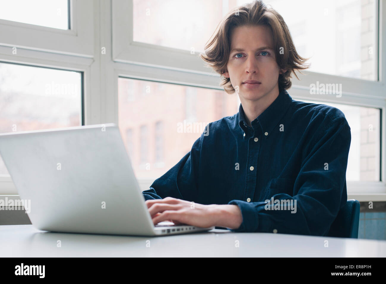 Man sitting desk using laptop hi-res stock photography and images - Alamy