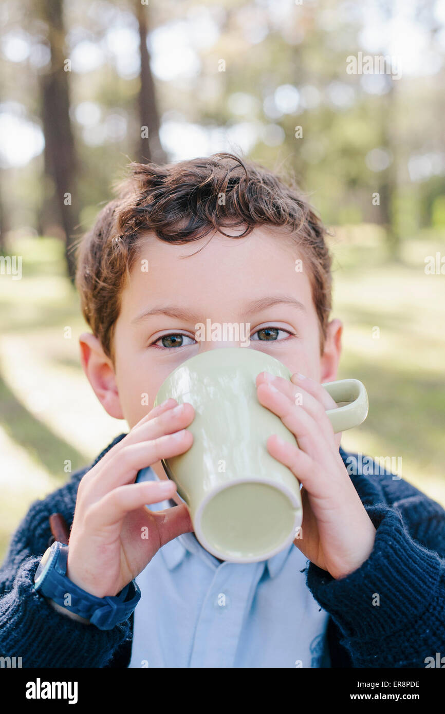 Close-up portrait of boy drinking coffee in forest Stock Photo - Alamy