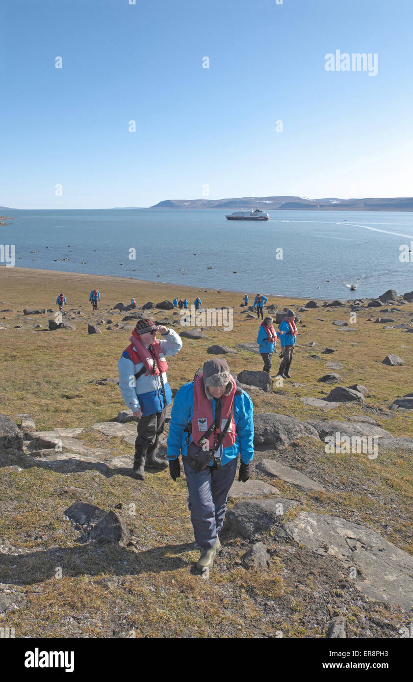Tourists ascending a hill above Sundneset, with view over Freemansundet ...