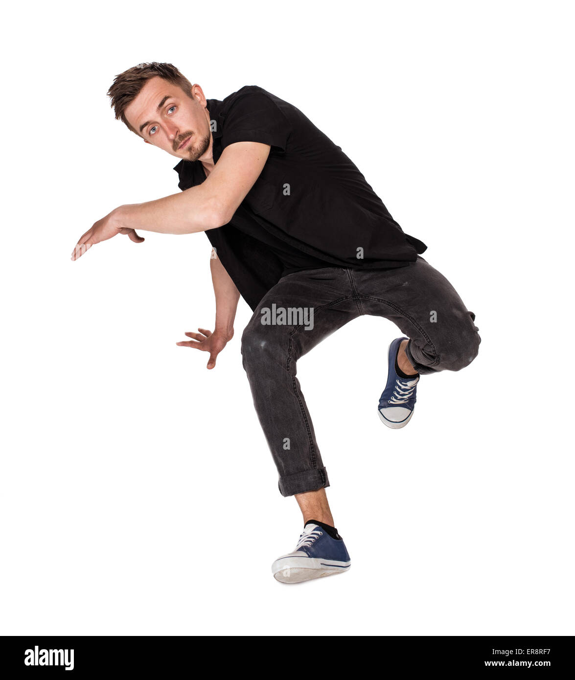 Break dancer doing one handed handstand against a white background ...