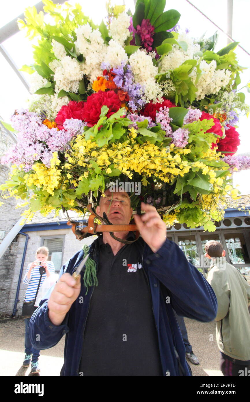 A garland maker puts the finishing touches to a floral headdress made ...