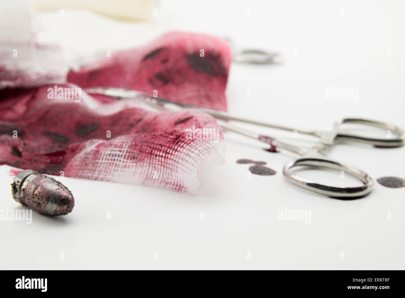 Surgical composition with bullet, blood and bandage Stock Photo - Alamy