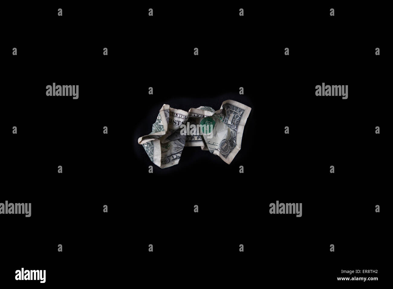 Crumpled dollar bill on black background Stock Photo - Alamy