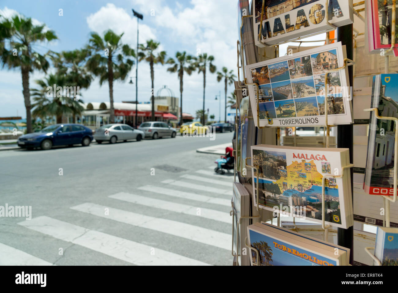A postcard rack of postcards of Malaga and Torremolinos on the seafront ...