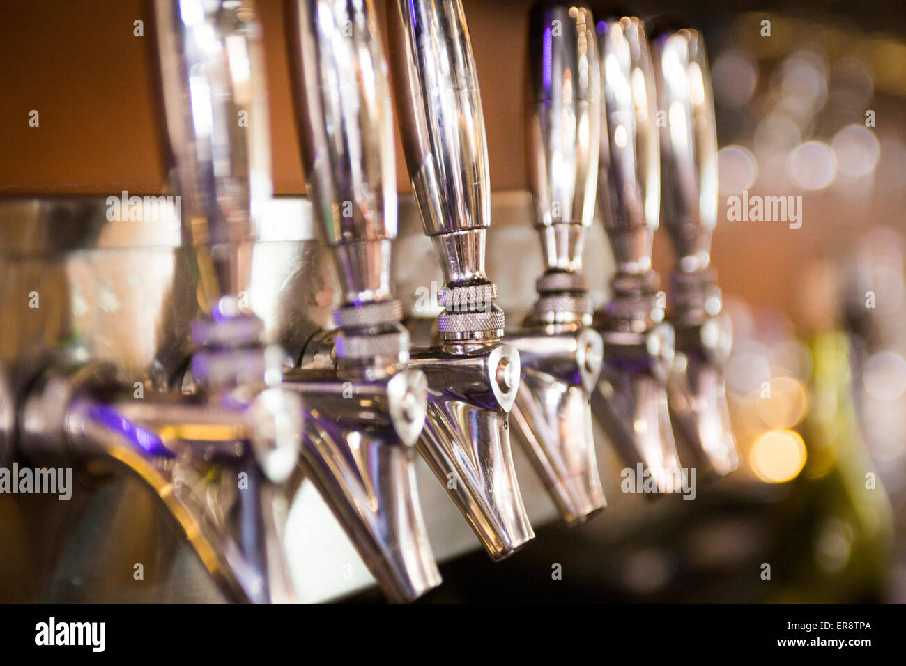 Unmarked shiny beer /wine taps in a row Stock Photo - Alamy