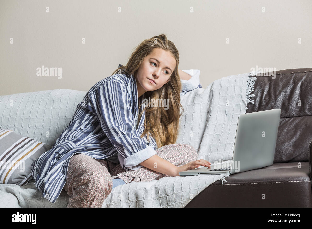 Teenage girl sitting sofa hi-res stock photography and images - Alamy