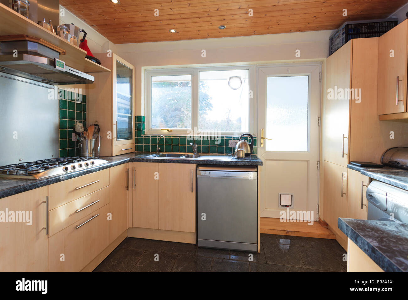 small modern style kitchen in english with timber clad ceiling Stock ...