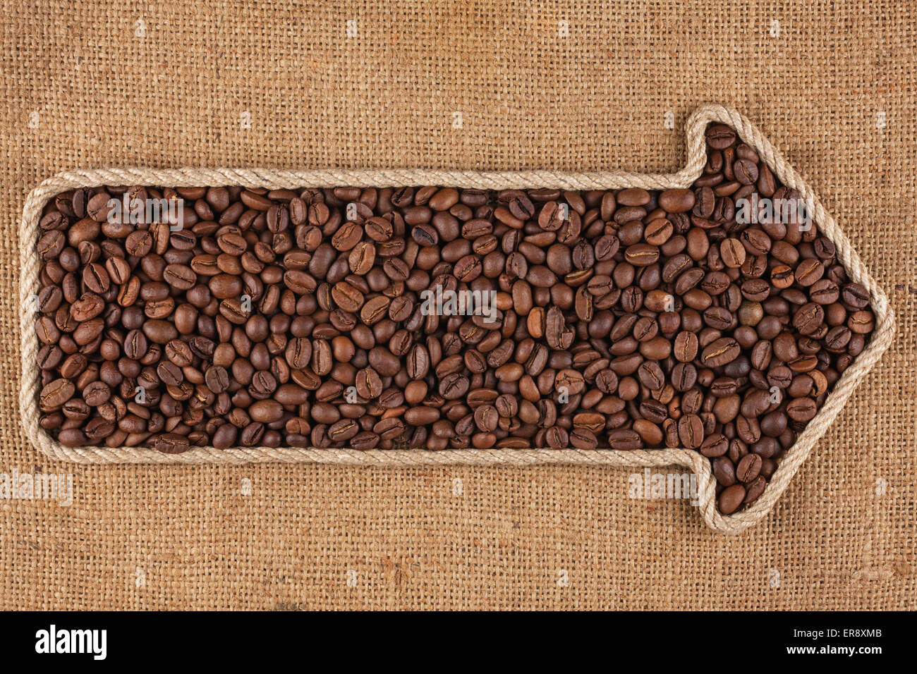 Pointer made from rope with coffee beans lying on sackcloth, with space ...