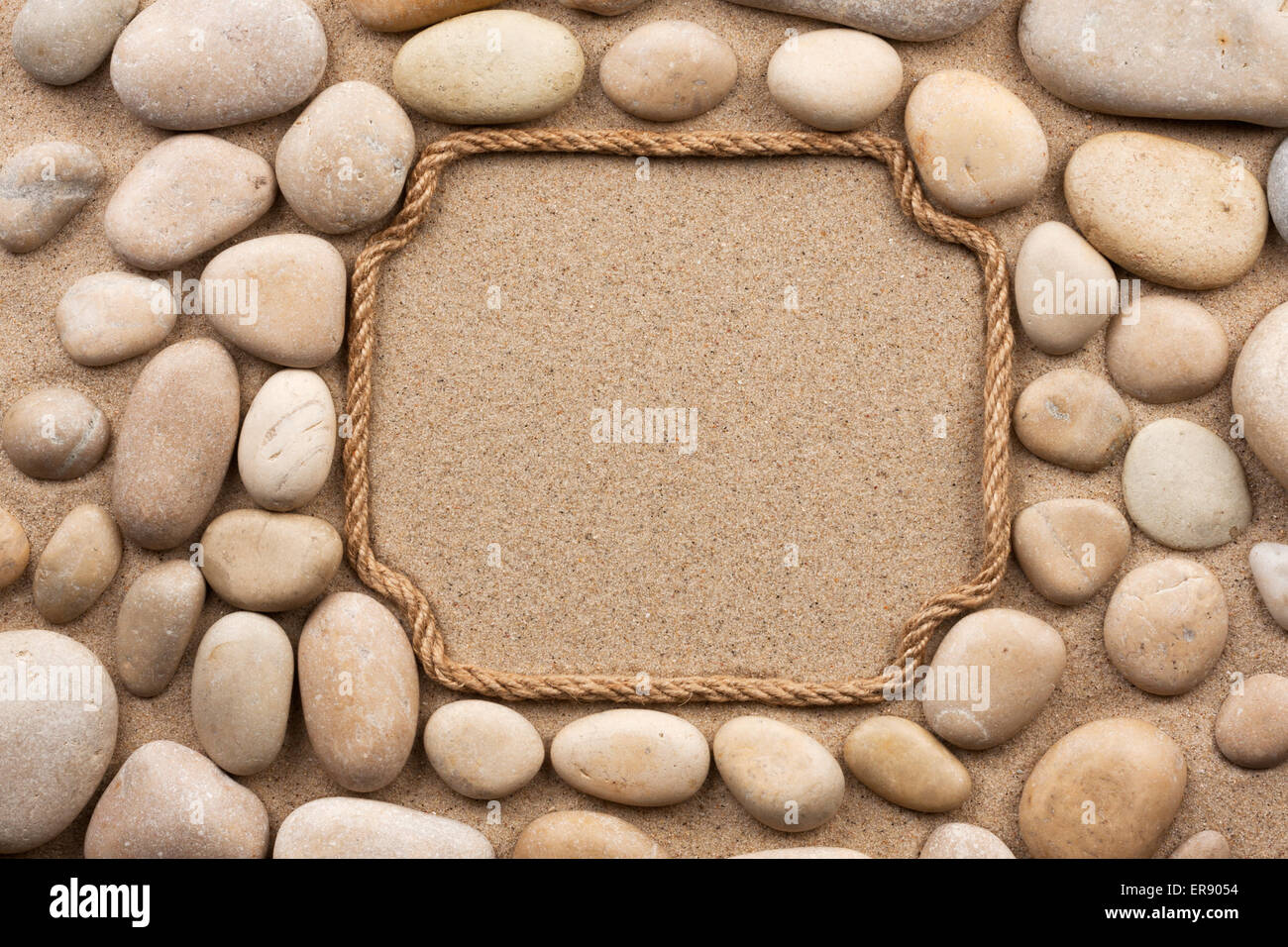 Pointer made of rope with white stones, lying on the sand Stock Photo ...