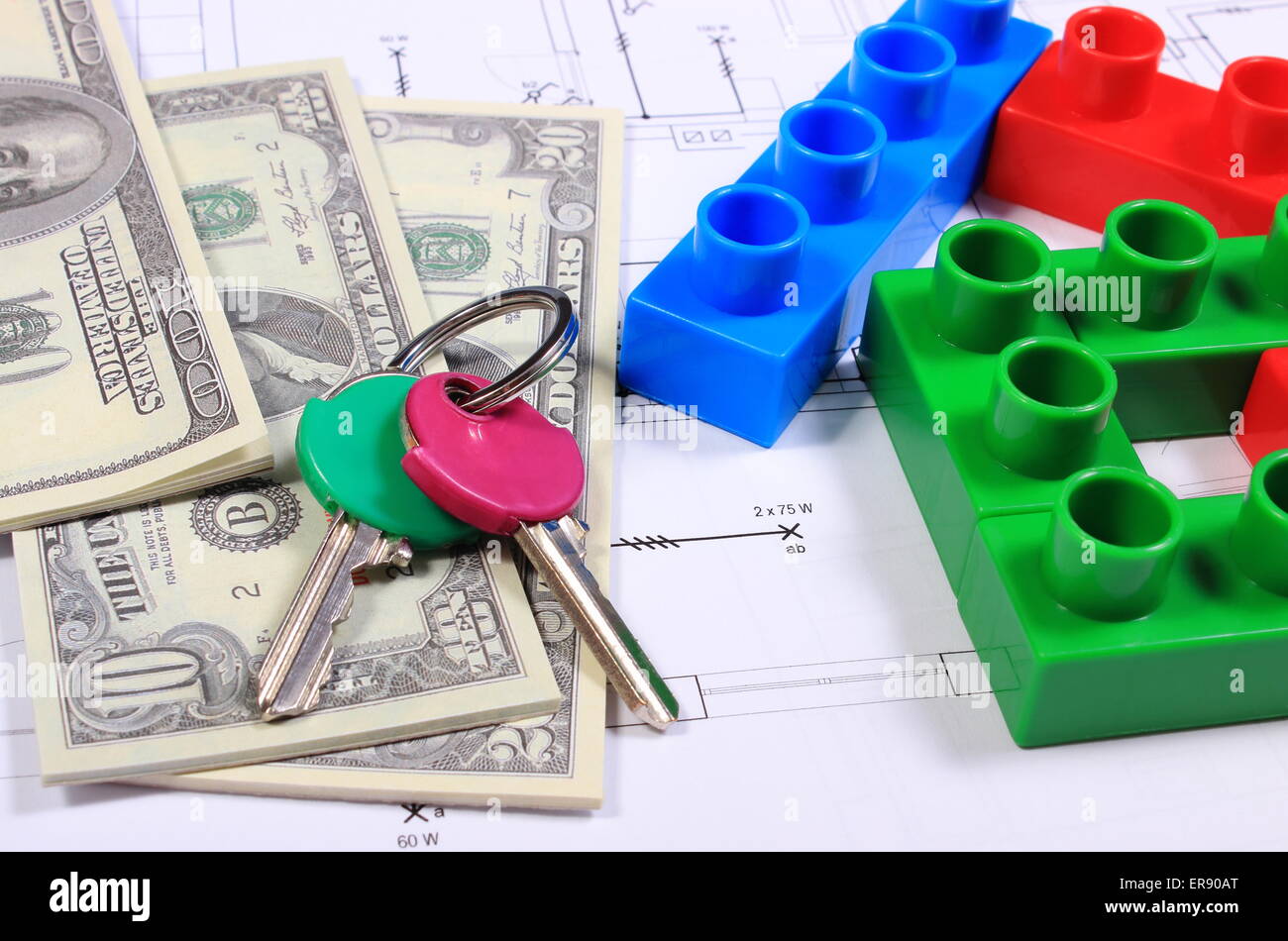 House shape of colorful building blocks, home keys and banknotes lying ...