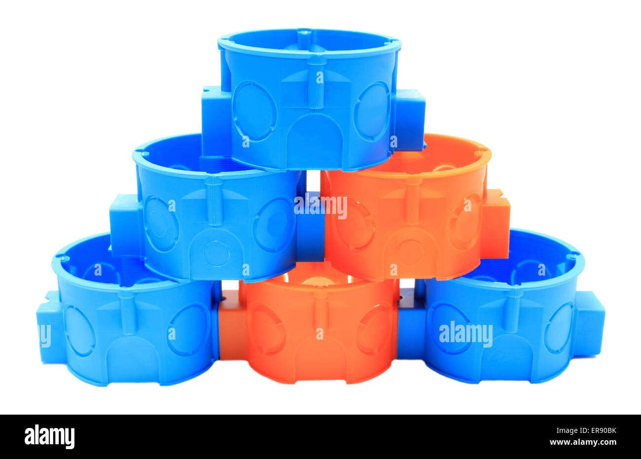 Stack of blue and orange plastic electrical boxes on white background ...