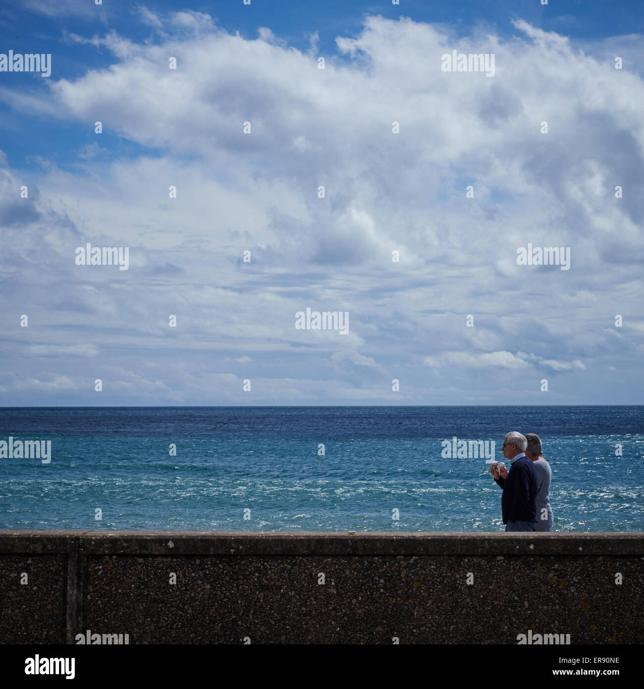 Couple walking along promenade wall hi-res stock photography and images ...