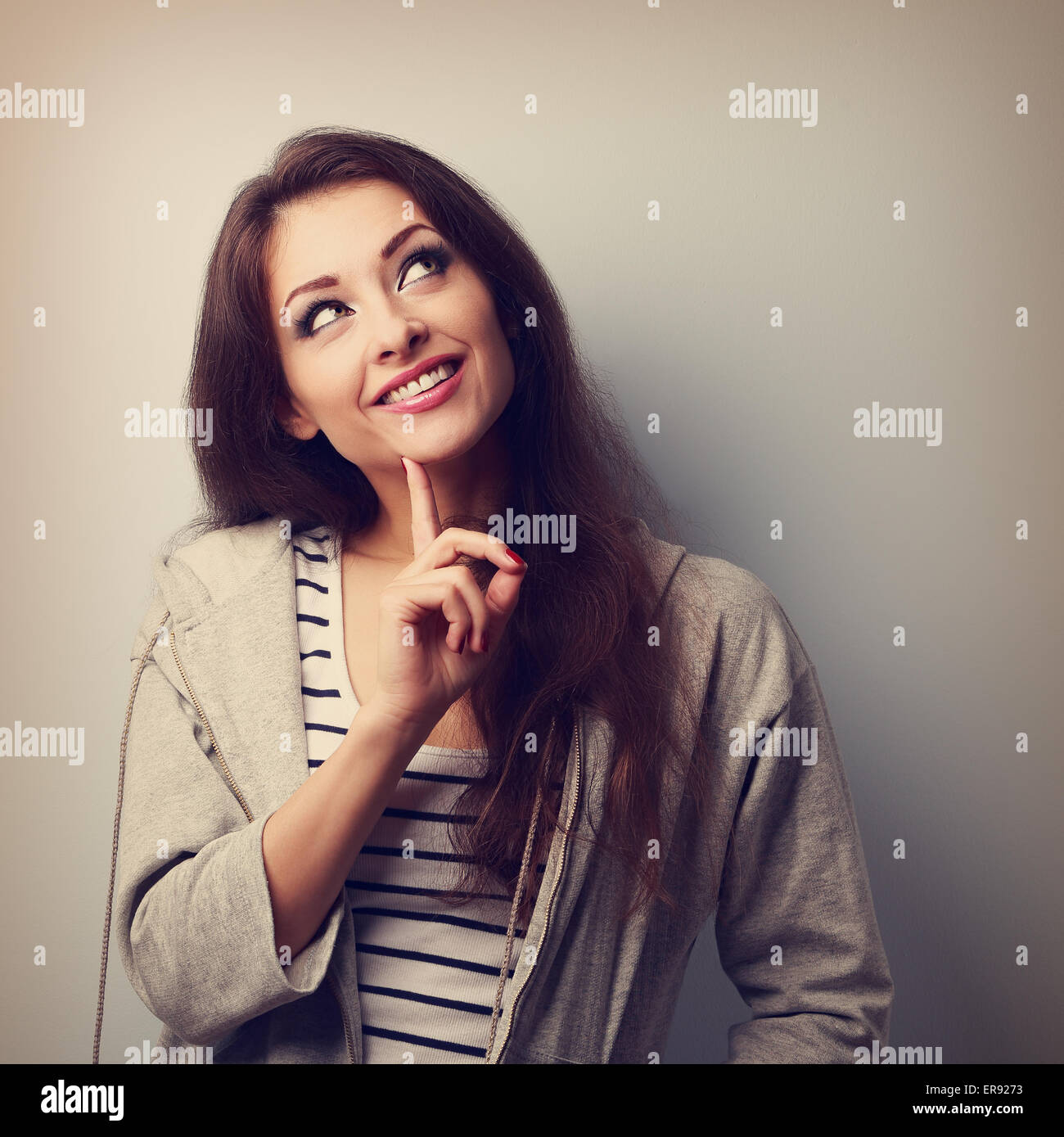Happy thinking woman in casual clothes looking up. Vintage portrait ...