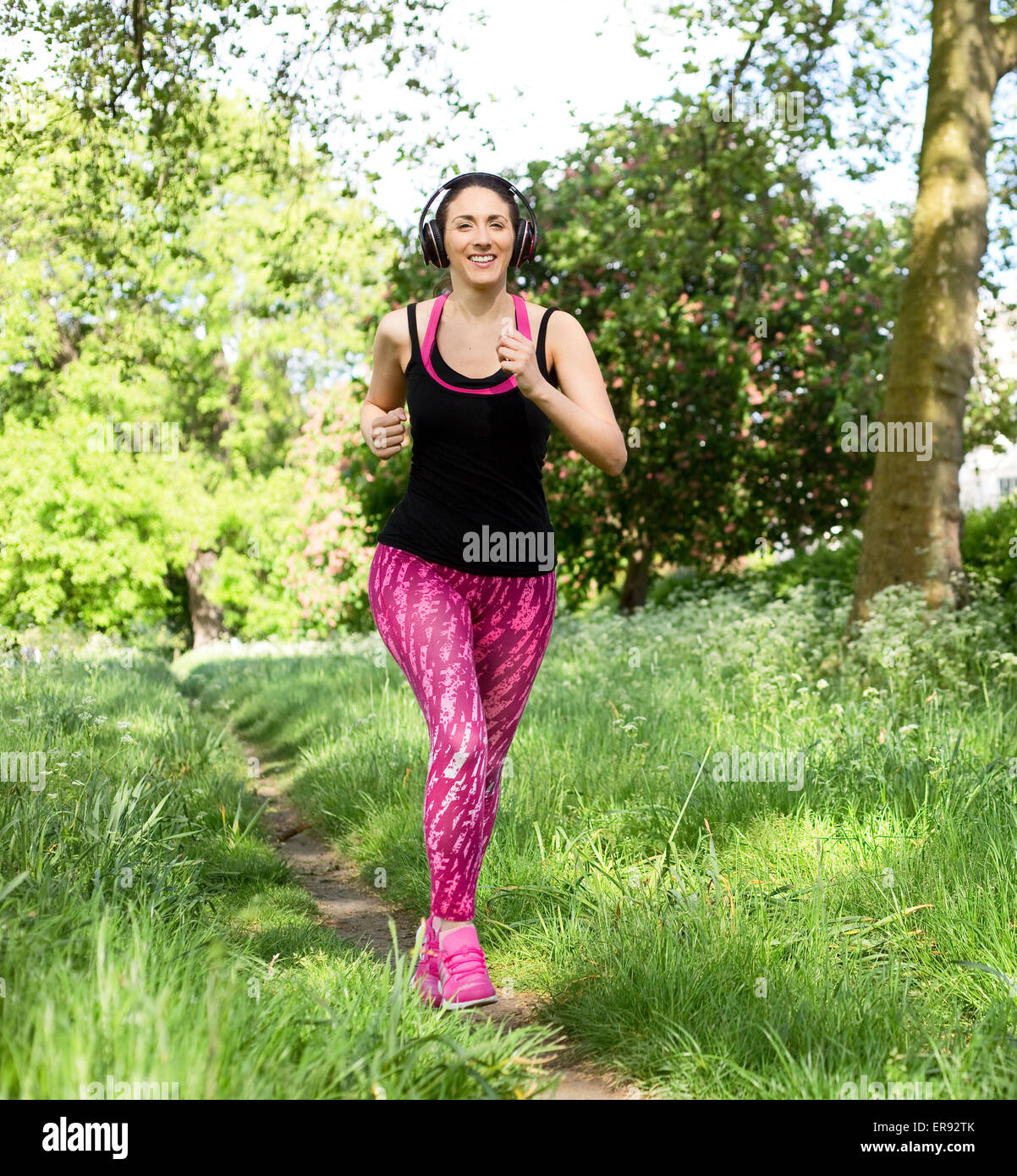 young woman running in the park Stock Photo - Alamy