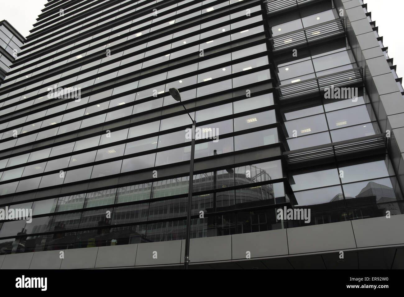 Grey sky view multi-storey glass and steel Bauhaus Office Building, 27 ...