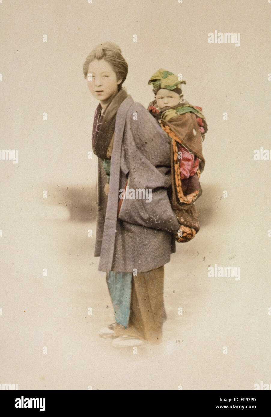 Woman carrying a child on her back hi-res stock photography and images ...