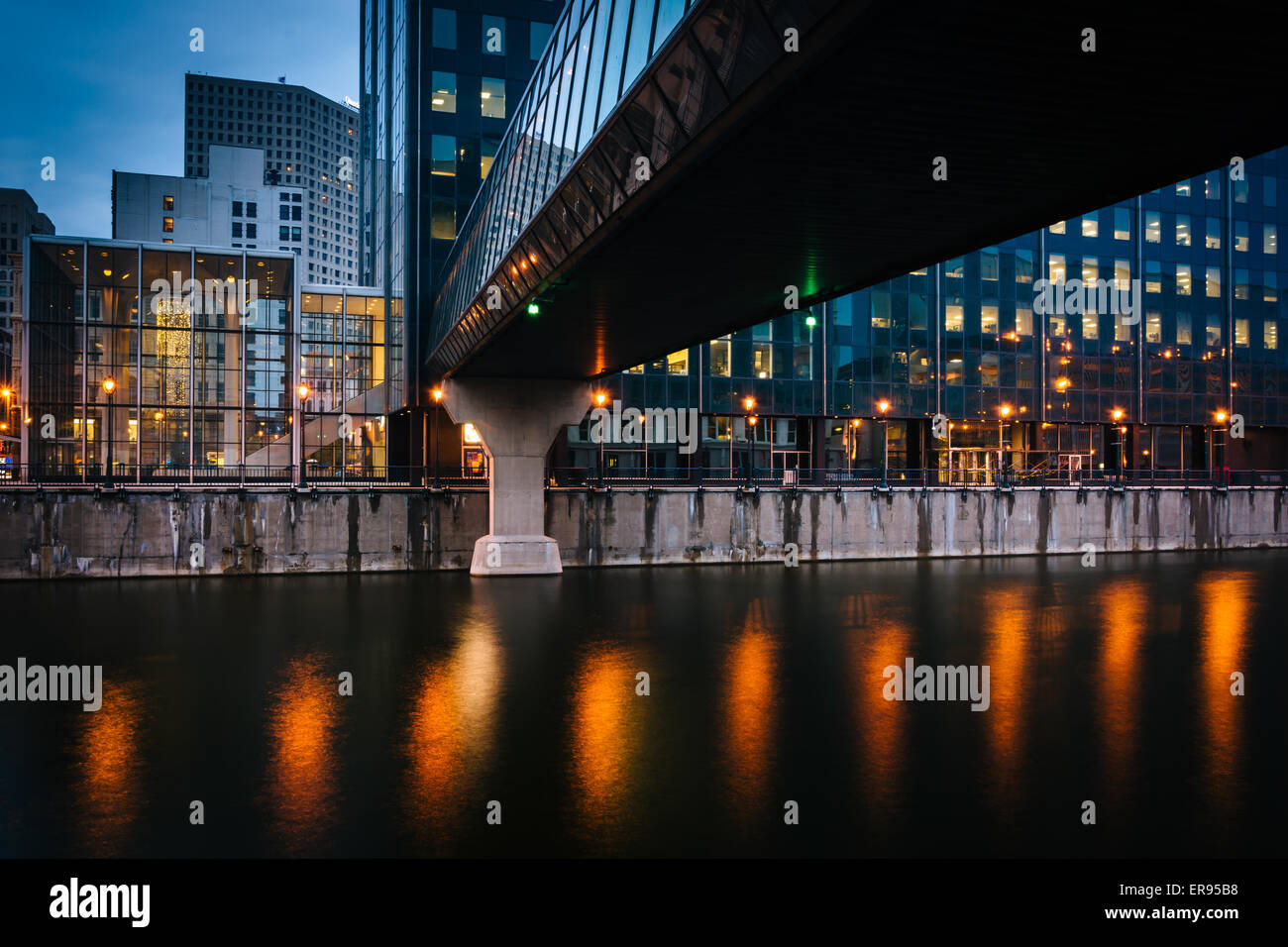 Buildings and pedestrian bridge over the Milwaukee River at night, in ...