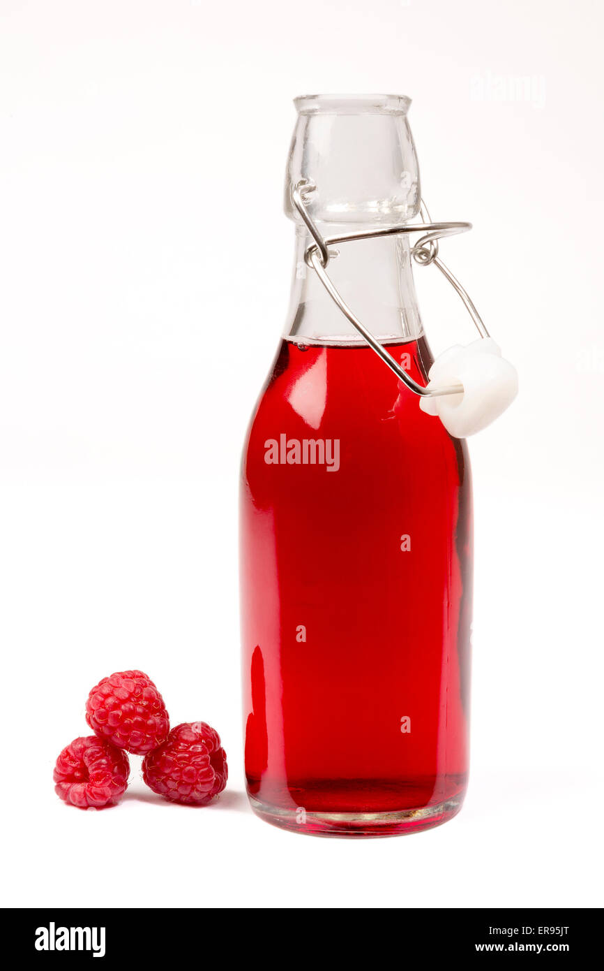 Raspberry Fruit Drink in Glass Bottle with raspberry berries isolated ...