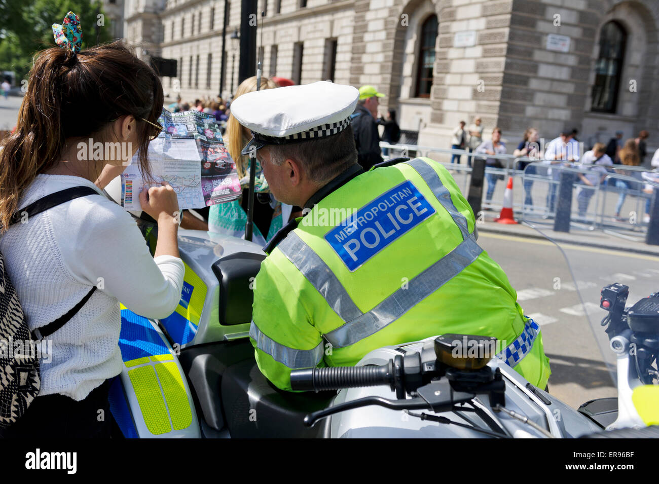A male traffic police officer in bright yellow jacket with high powered ...