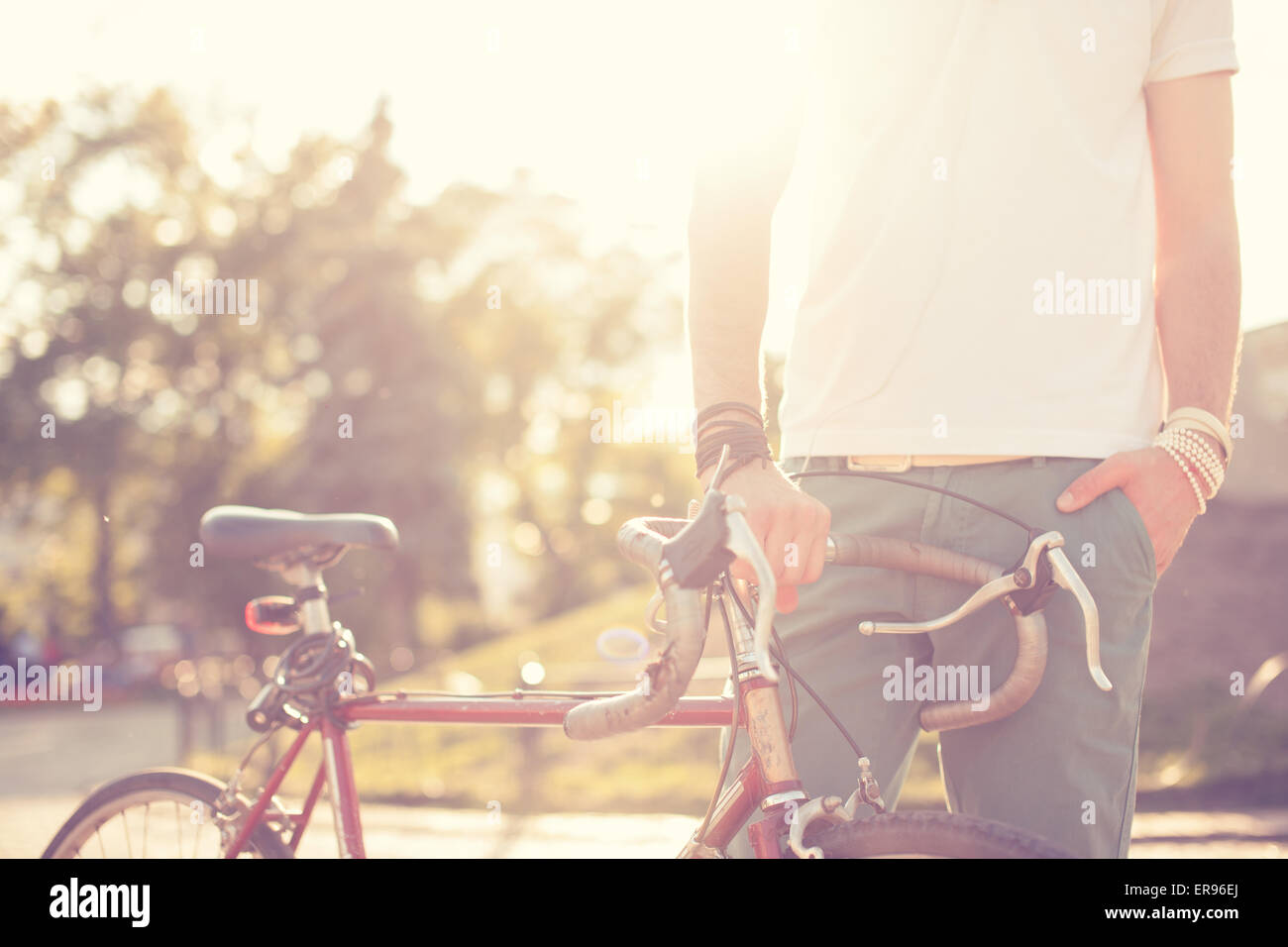 Stylish guy holding vintage race bike Stock Photo - Alamy