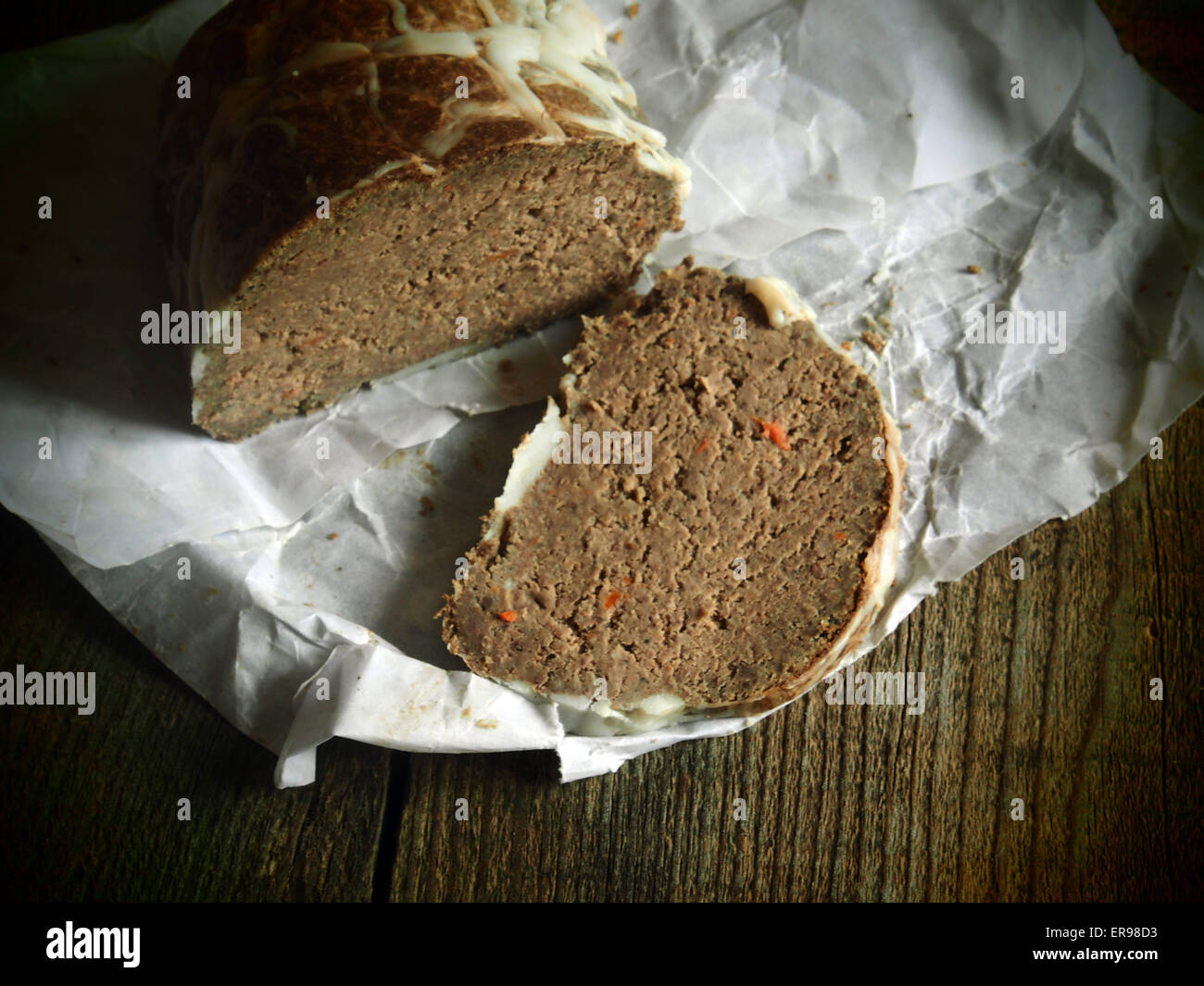 Homemade goose pate in a natural casing on a piece of oiled packing ...