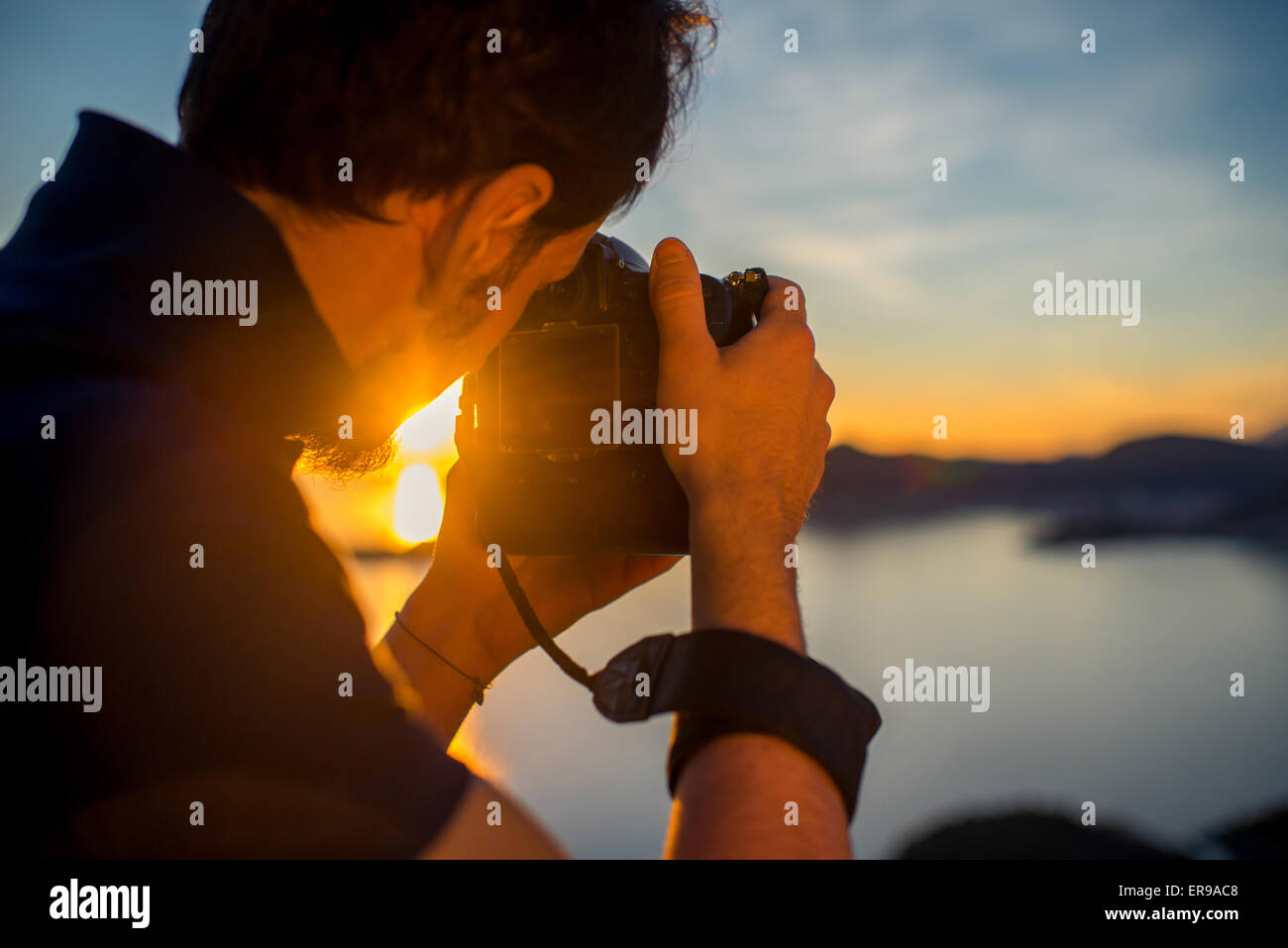Man photographing sunset on the top of mountain Stock Photo - Alamy