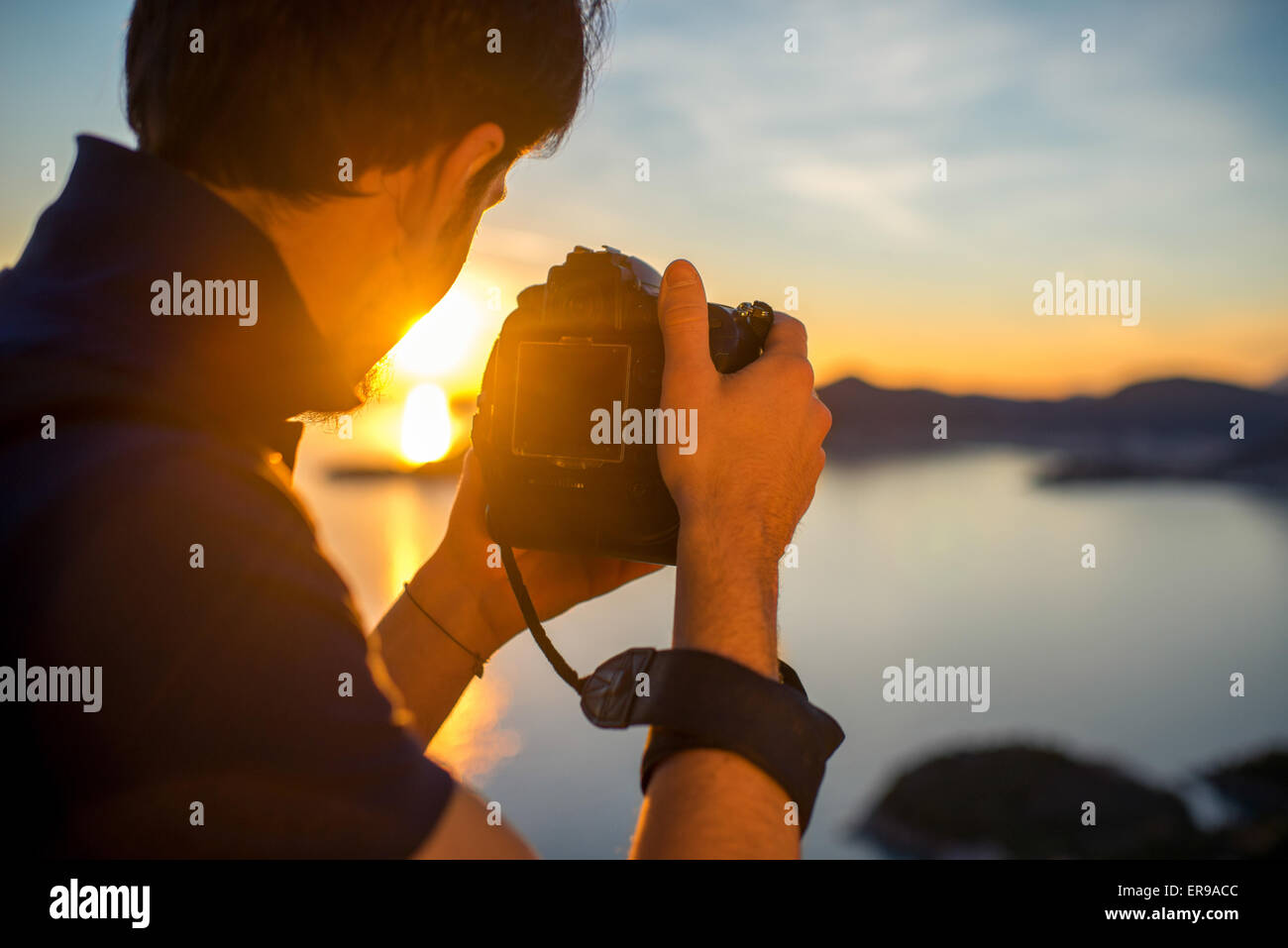 Man photographing sunset on the top of mountain Stock Photo - Alamy
