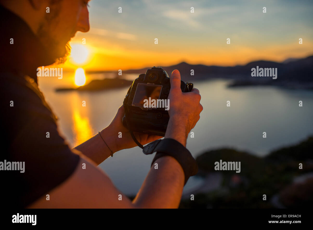 Man photographing sunset on the top of mountain Stock Photo - Alamy