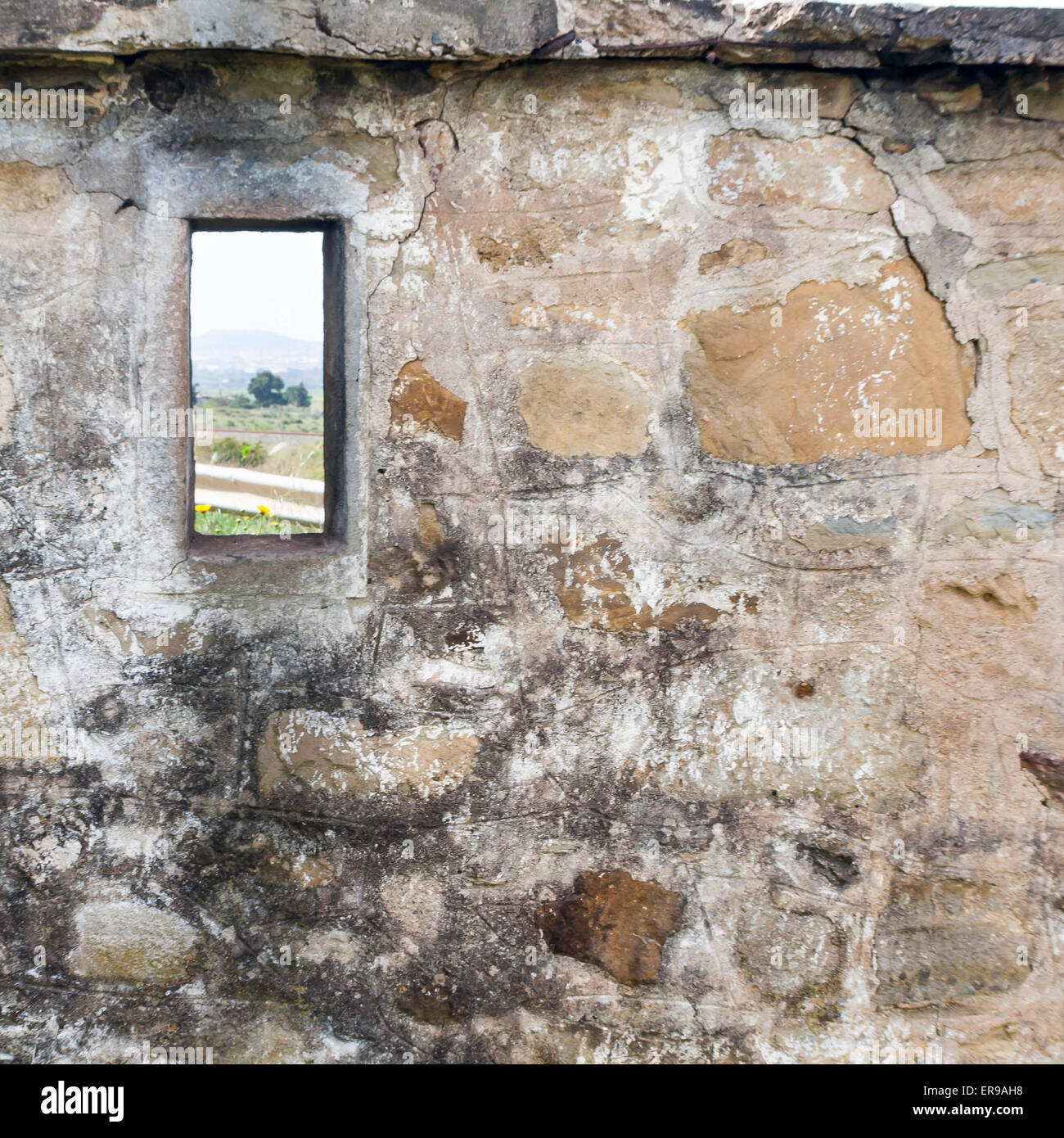 Stone wall little window. Behind the wall another world Stock Photo - Alamy