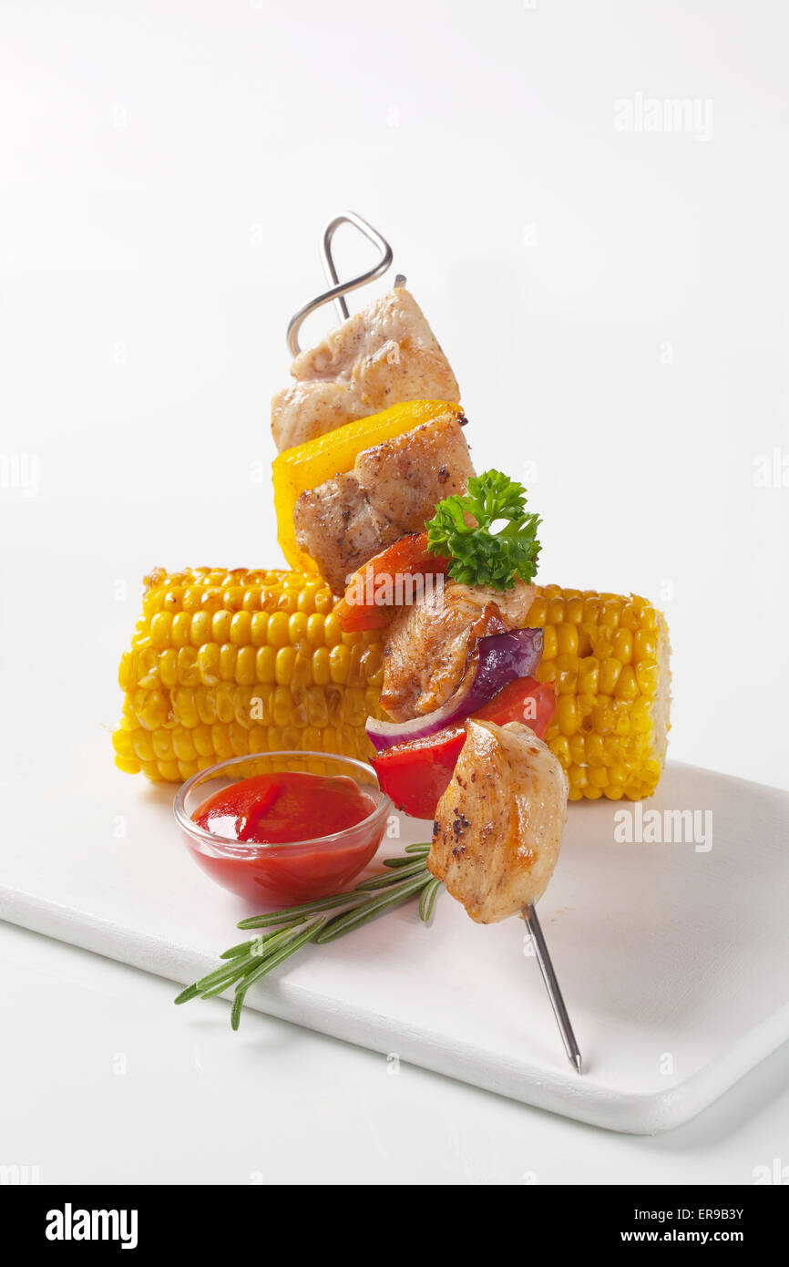 Chicken shish kebab and roasted corn on the cob Stock Photo - Alamy