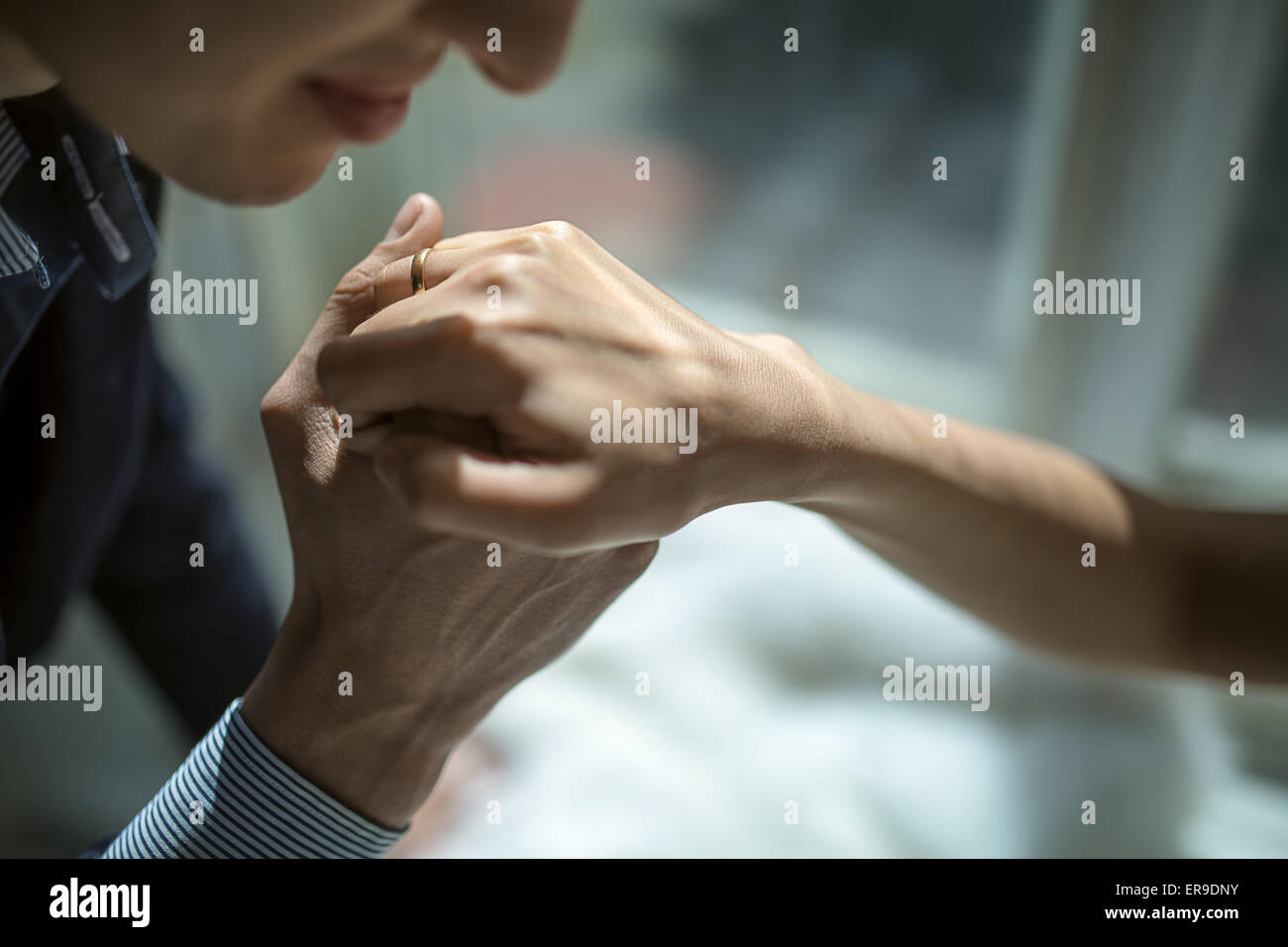 Two hands holding rings hi-res stock photography and images - Alamy