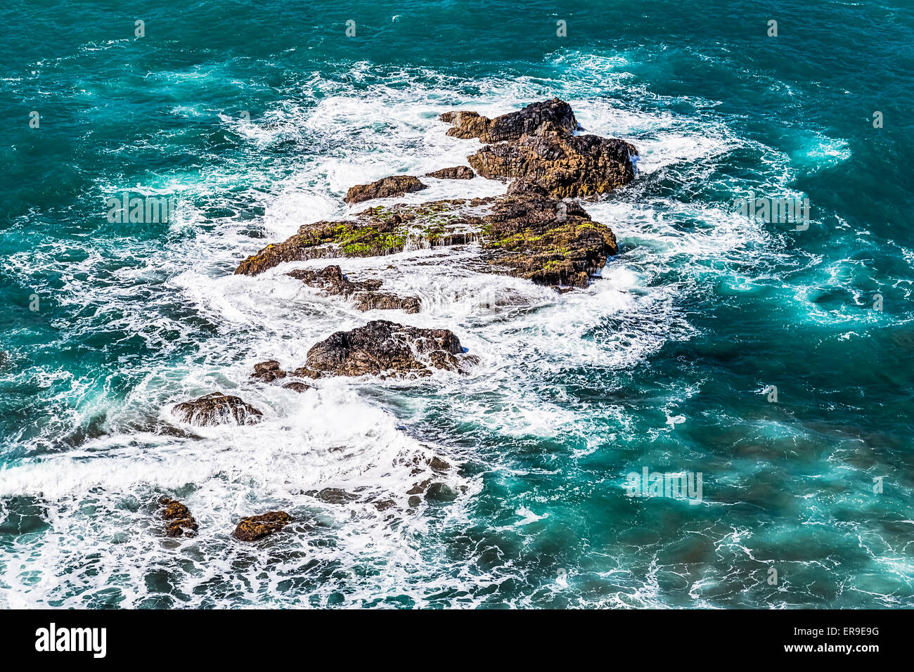 Stones in waves of ocean on shore of Atlantic ocean in Tenerife Canary ...