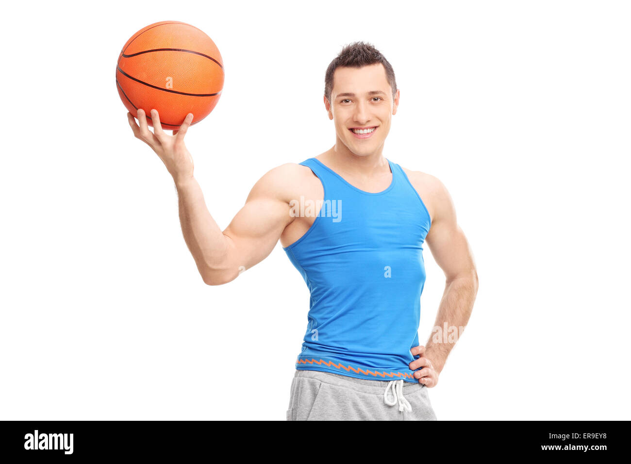 Handsome young man posing with a basketball in his hand isolated on ...