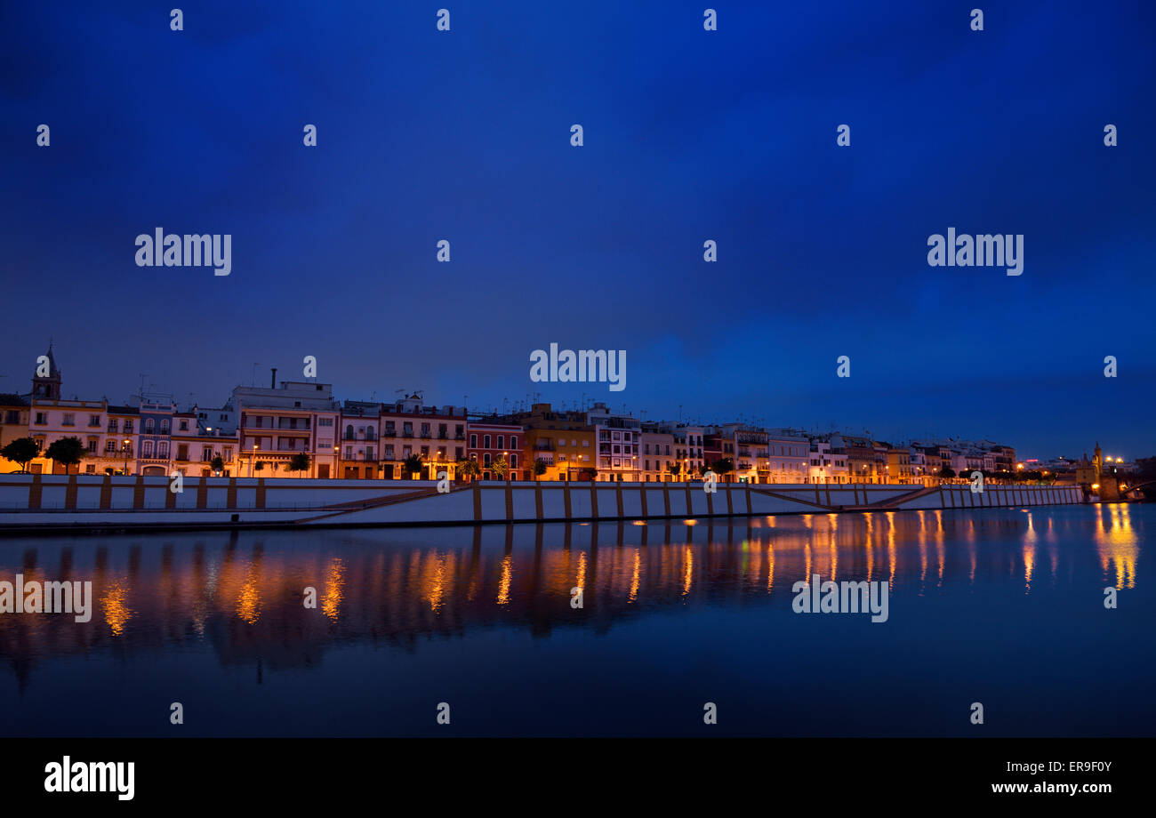 Houses on Betis street to Isabel bridge Seville reflected at dawn in ...