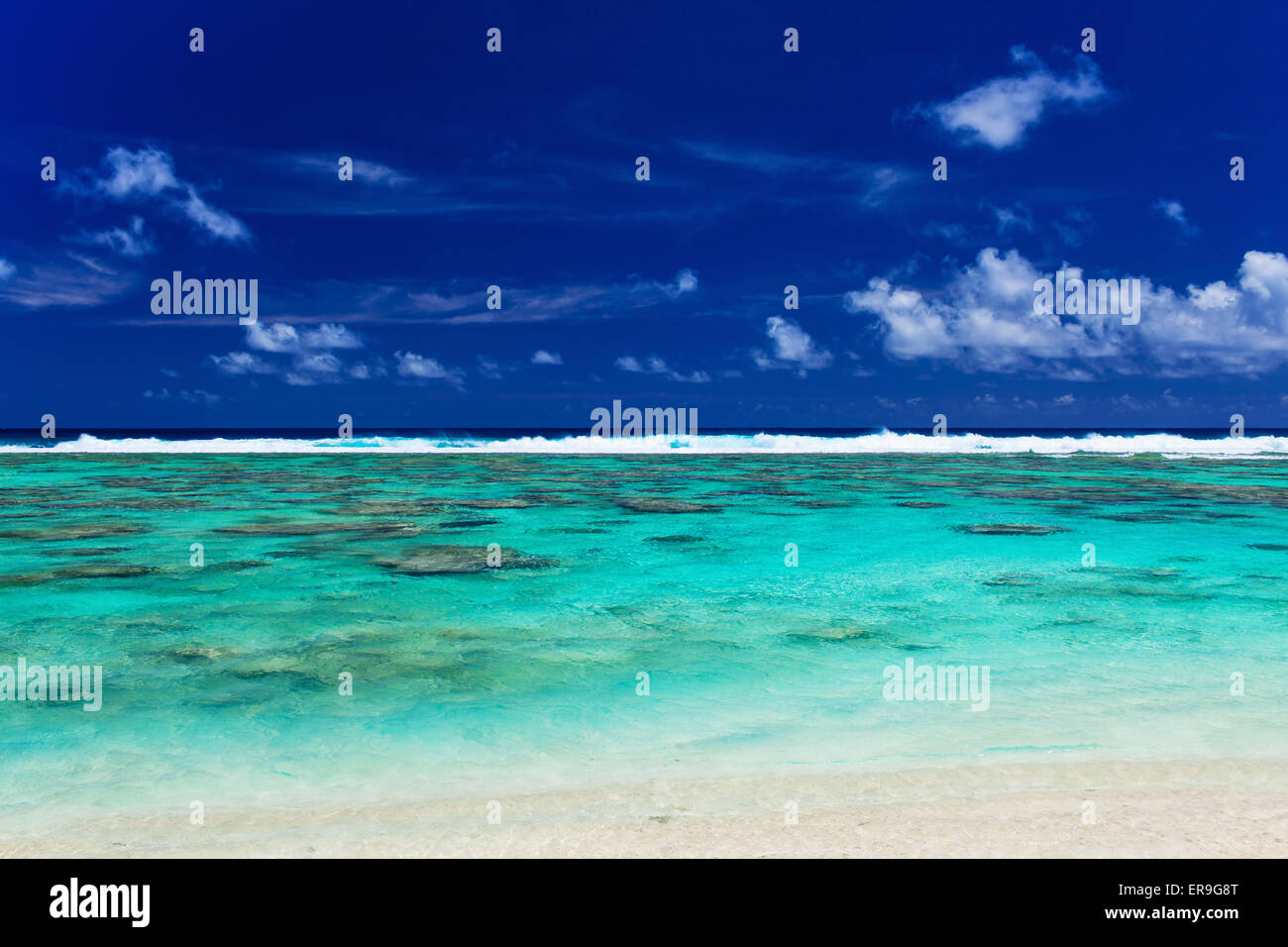 Tropical beach with coral reef and surf waves on Roratonga, Cook ...