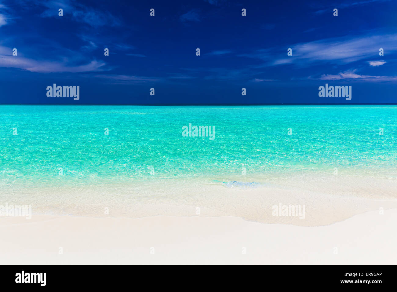 A vibrant shot of clear empty beautiful tropical beach with blue sky ...