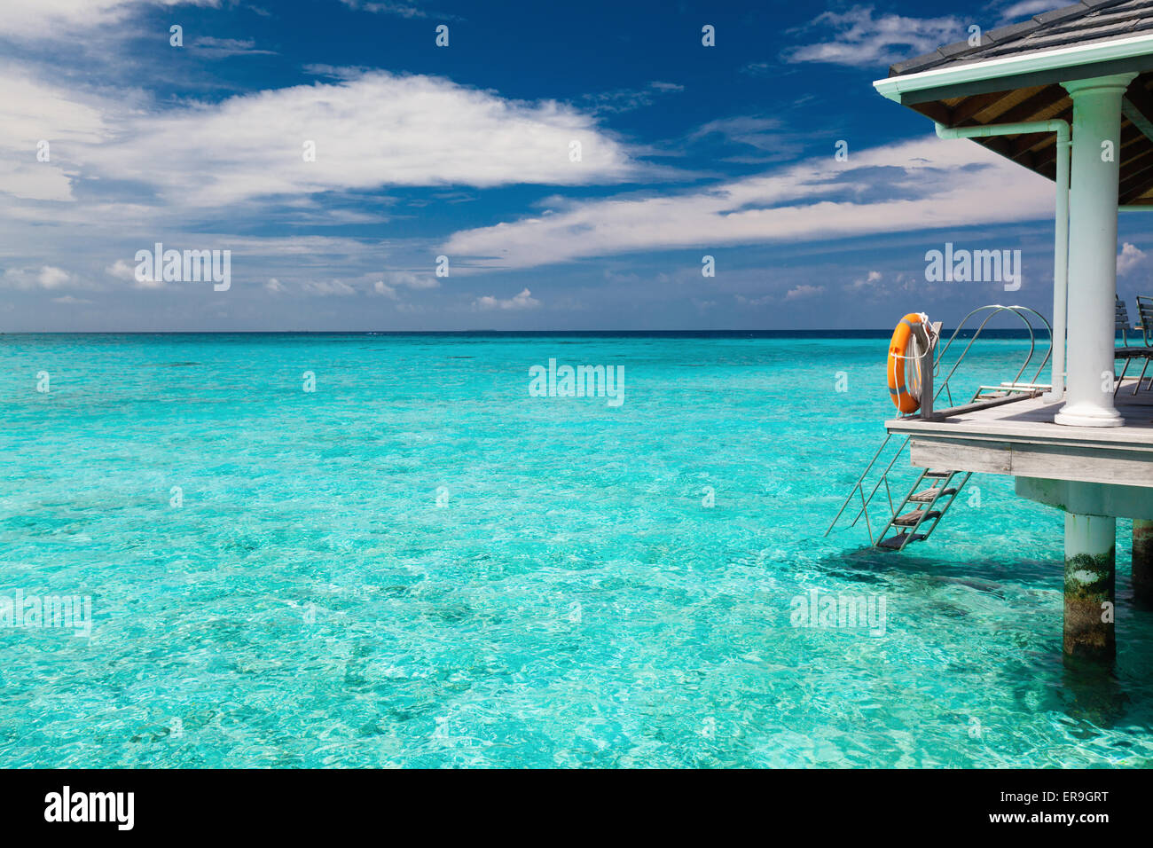 Metal stairs from wodden jetty leading into shallow tropical sea Stock ...
