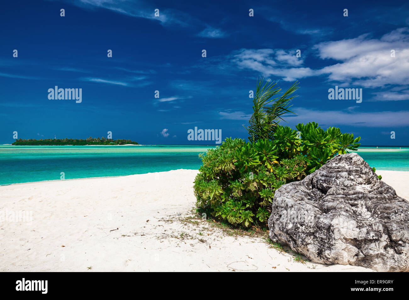 Dreamy crystal clear sea with a rock on the white sandy beach Stock ...