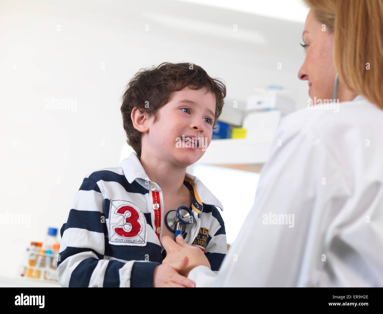 PROPERTY RELEASED. MODEL RELEASED. Doctor checking a 5 year old boy's ...