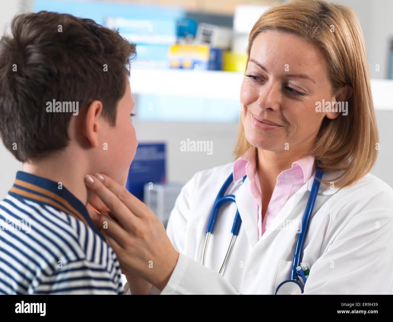 PROPERTY RELEASED. MODEL RELEASED. Doctor checking 10 year old boys ...
