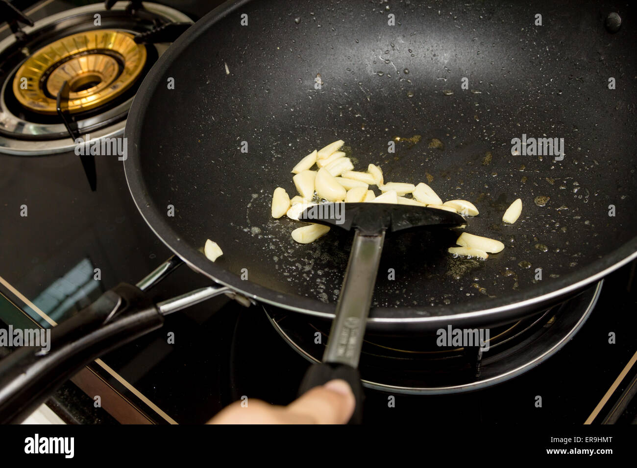 garlic in frying pan Stock Photo - Alamy