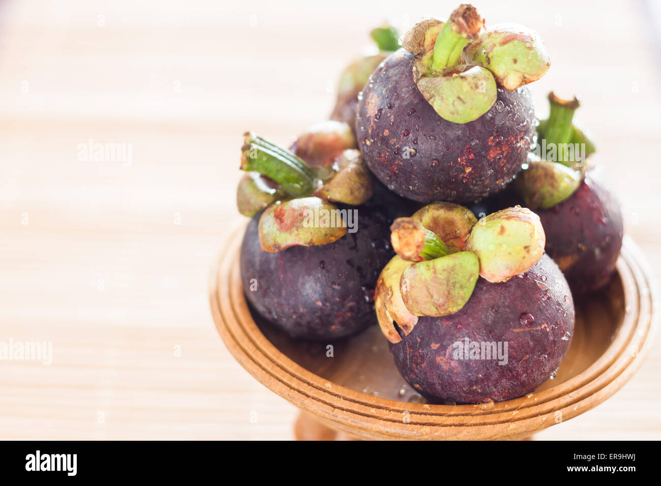 Group of mangoesteen on wooden tray, stock photo Stock Photo - Alamy