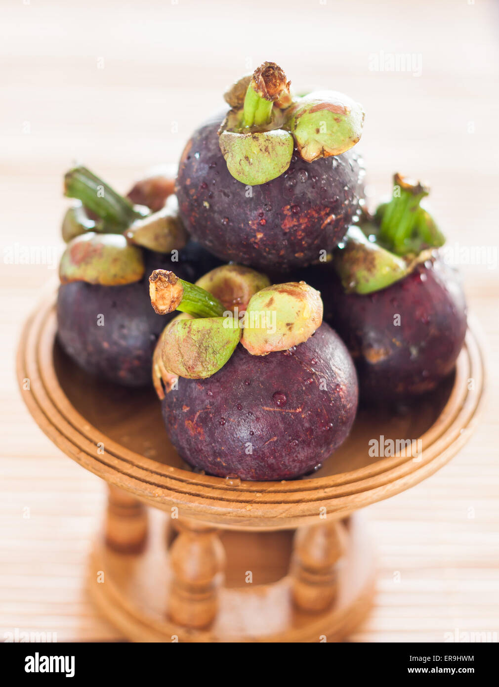 Group of mangoesteen on wooden tray, stock photo Stock Photo - Alamy