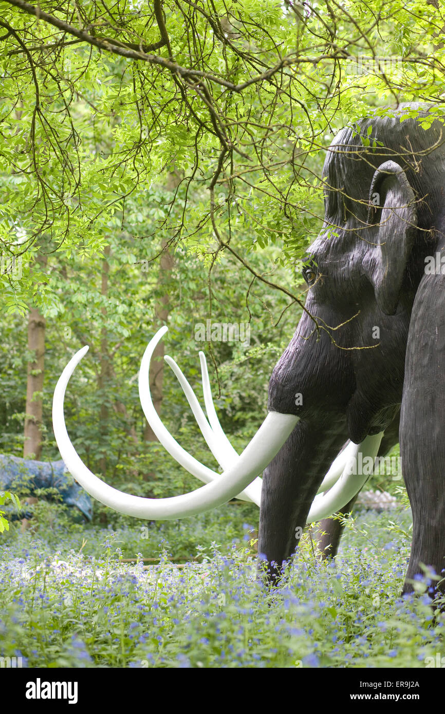 Mammoth Dinosaur Statue walking in the woodlands of England Stock Photo ...