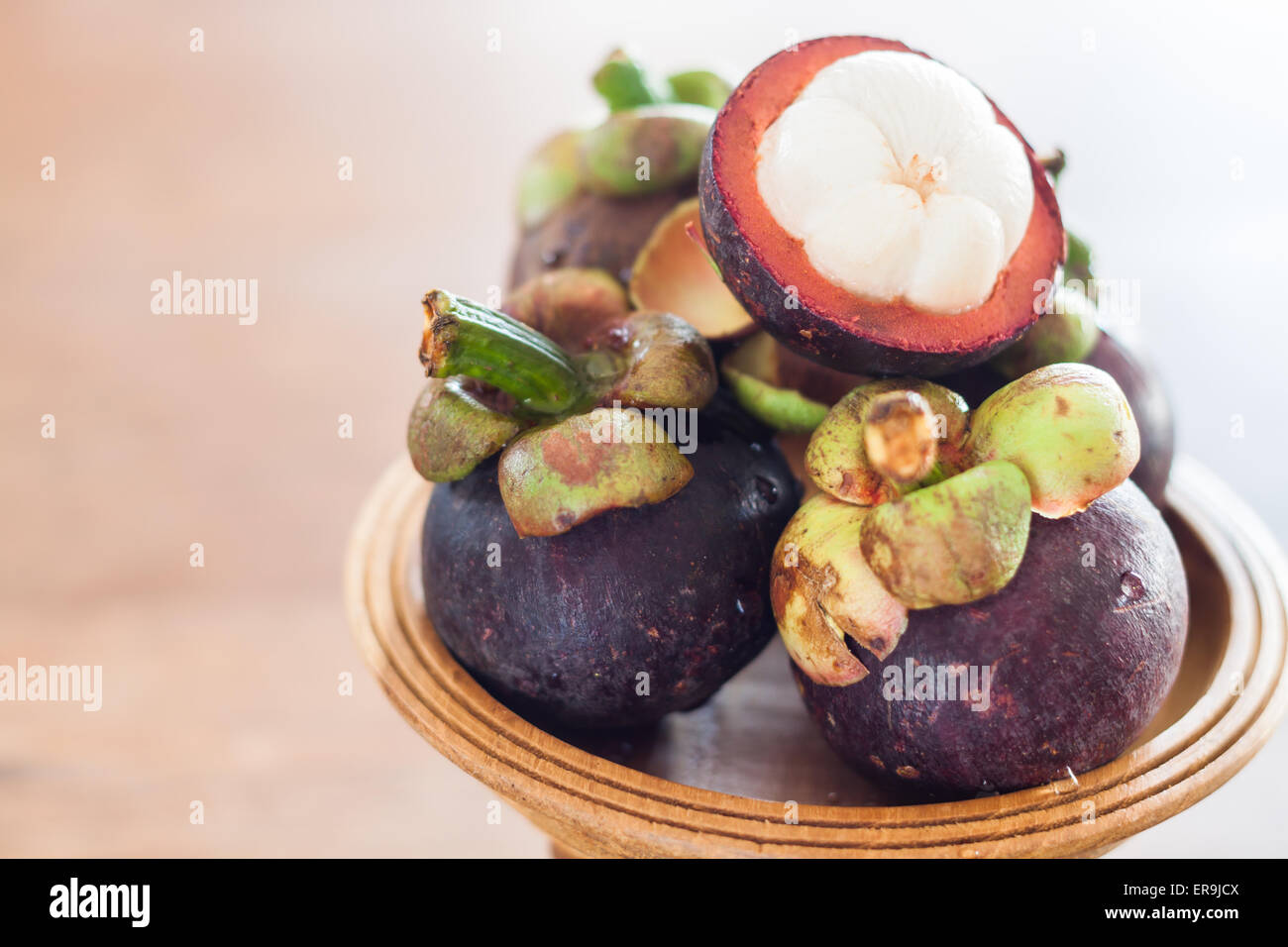 Group of mangoesteen on wooden tray, stock photo Stock Photo - Alamy
