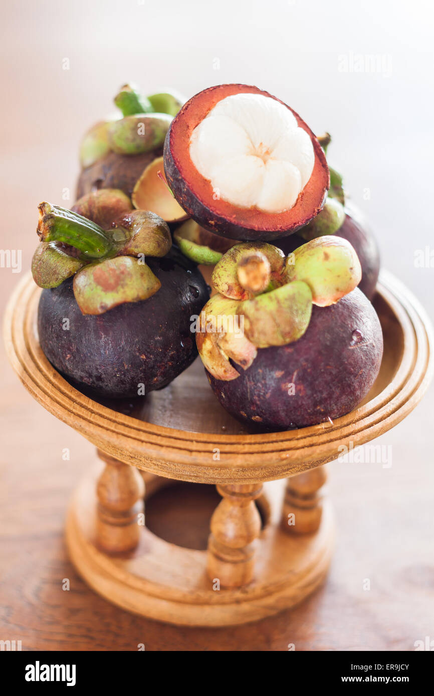 Group of mangoesteen on wooden tray, stock photo Stock Photo - Alamy