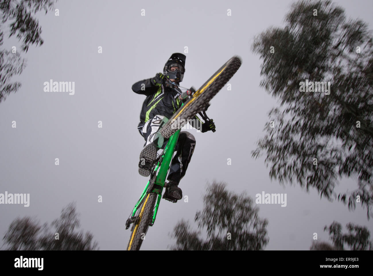 Mountain biker on a downhill course jumping through the air - motion ...