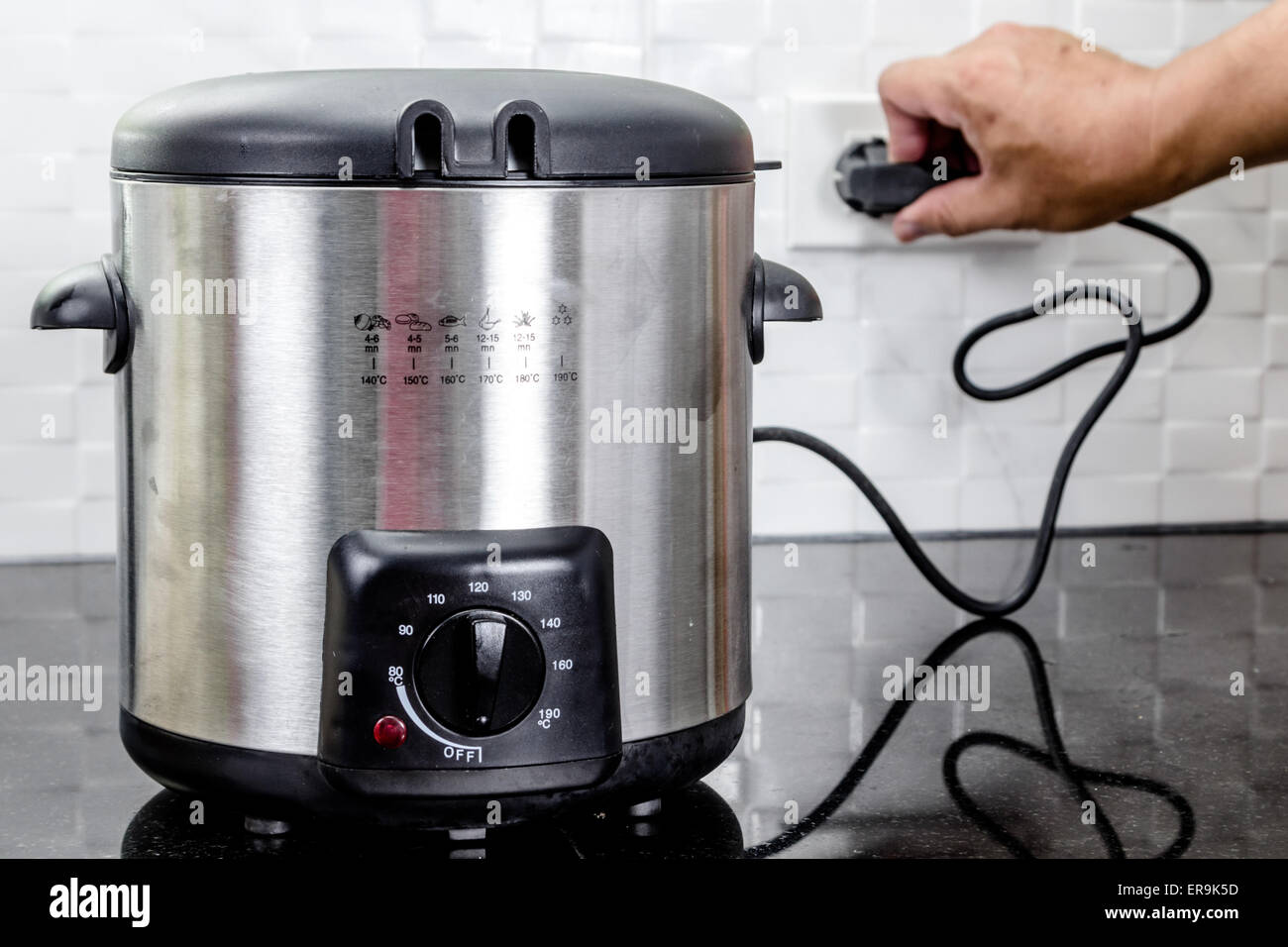 hand Plug in the fryer Stock Photo - Alamy