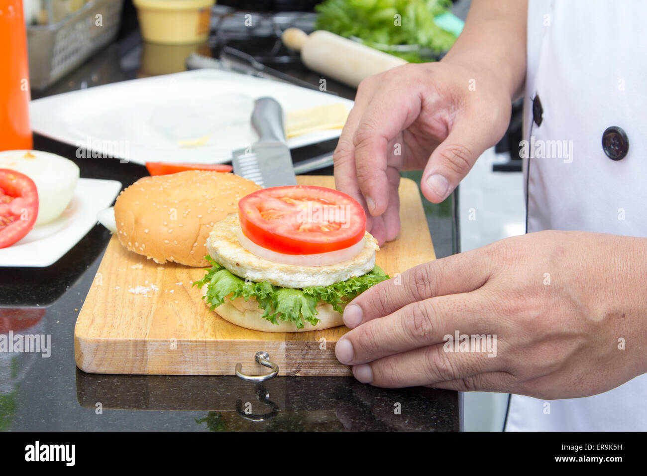 Chef making American cheese burger in kitchen Stock Photo - Alamy