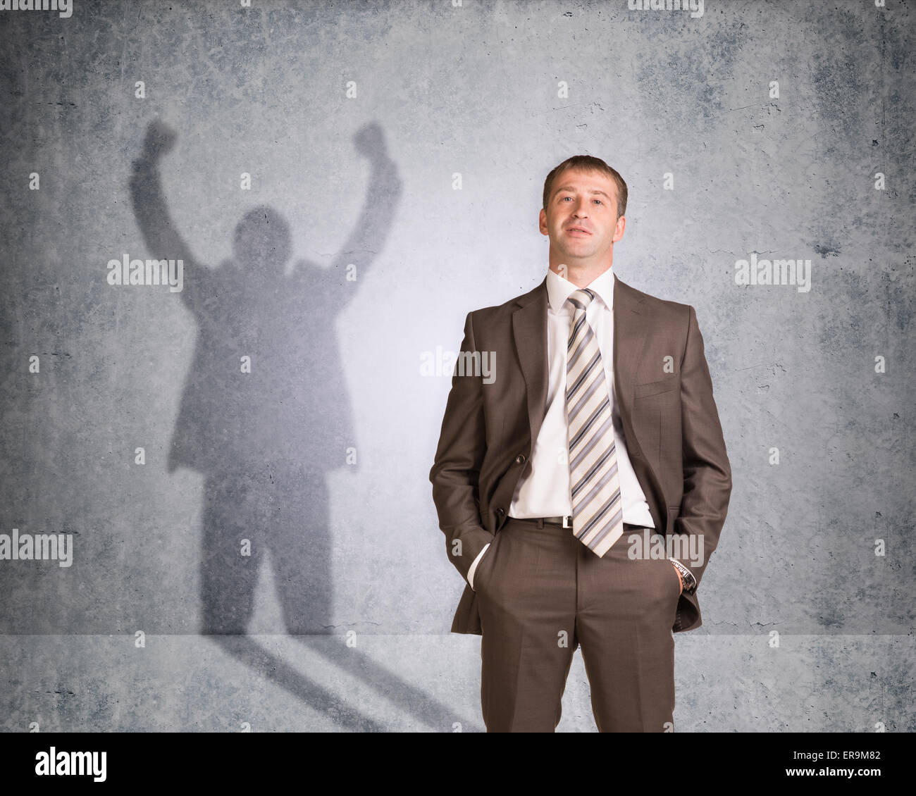 Businessman with shadow showing win Stock Photo - Alamy